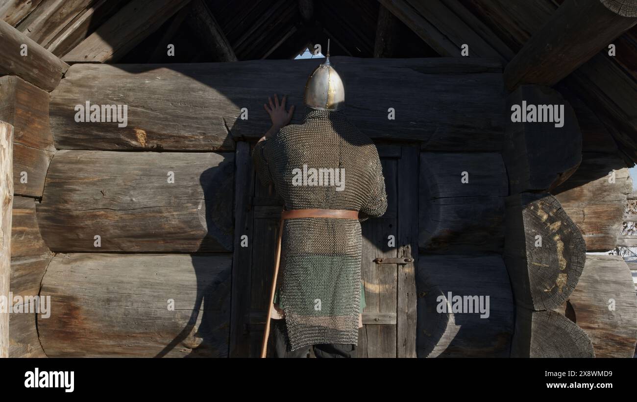 Rear view of an ancient russian bogatyr in chain armour and helmet ...