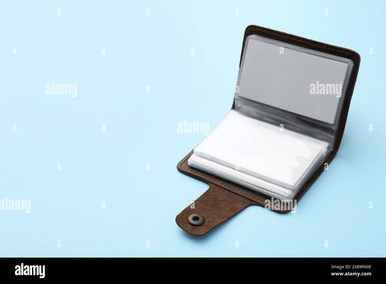 Leather business card holder with blank cards on light blue background ...