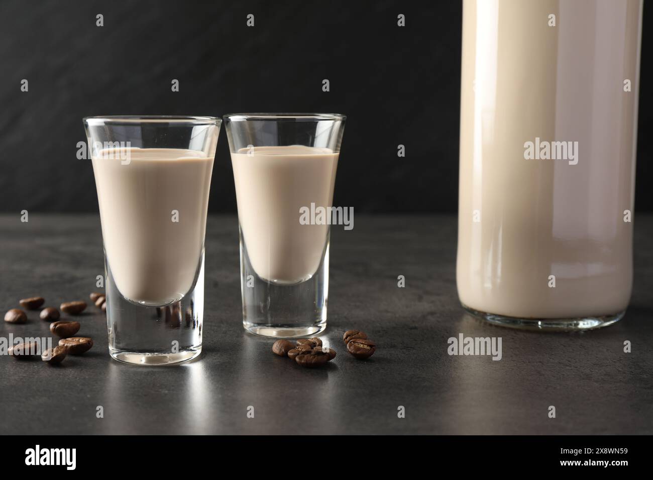 Coffee cream liqueur in glasses, bottle and beans on grey table Stock ...
