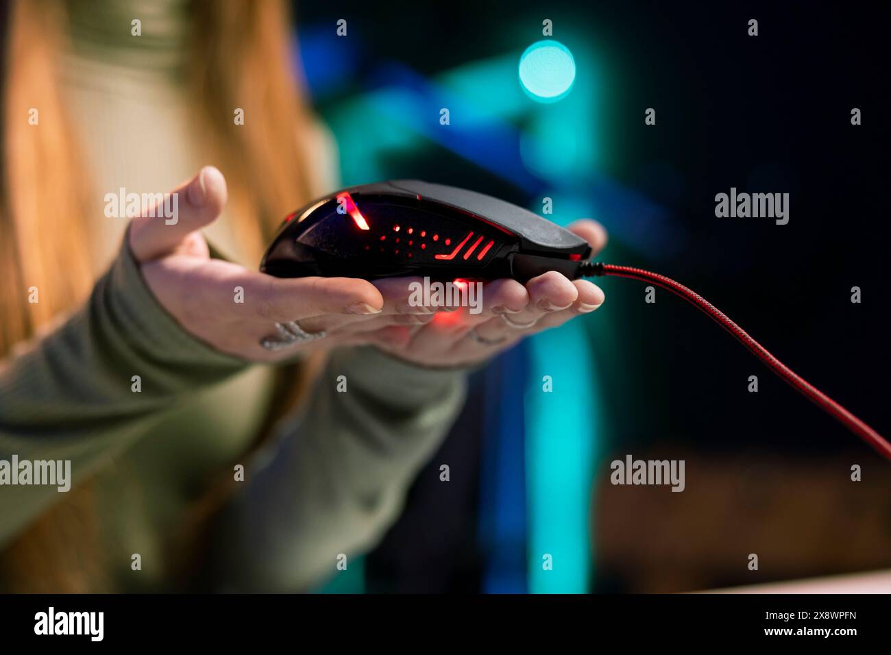 Media star filming review of newly released gaming led lights mouse, close up shot. Woman giving ...