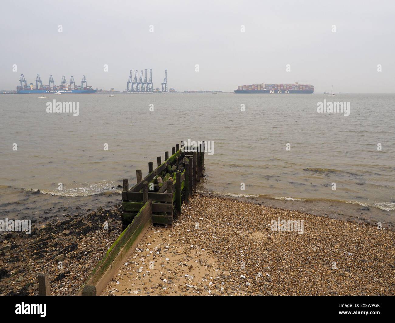 Felixstowe container port seen from Harwich, timber groin in the ...