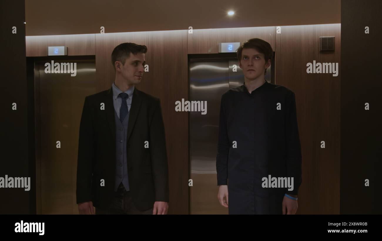 Two businessmen using elevator hi-res stock photography and images - Alamy
