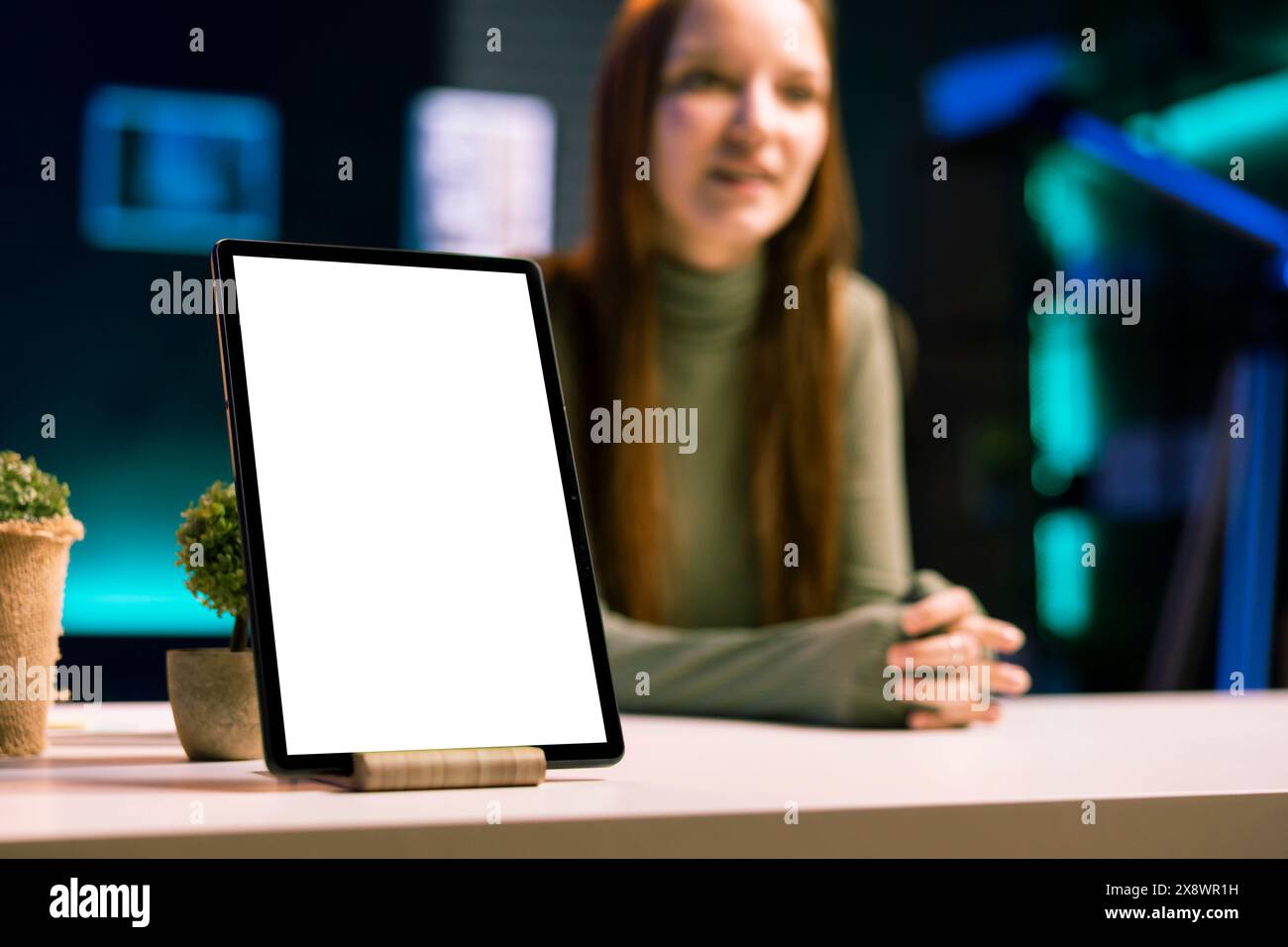 Focus on mockup tablet with gen Z teenager in blurry background doing ...
