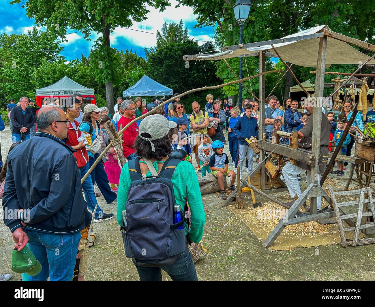 This image shows a group of people gathered around an outdoor ...