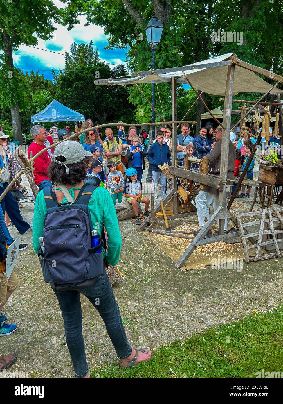 This image shows a group of people gathered around an outdoor ...