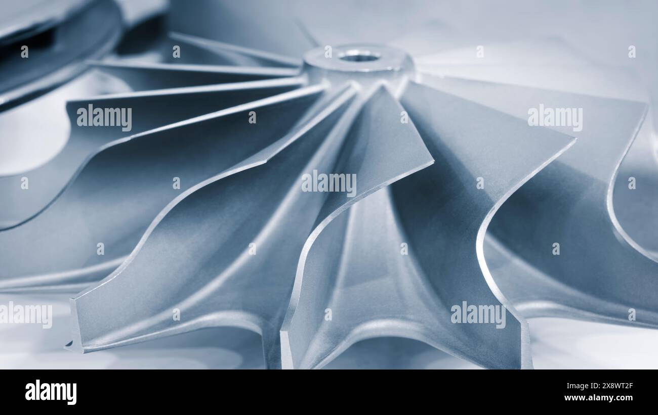 A silver object with a spiral design. The spiral design is made of ...