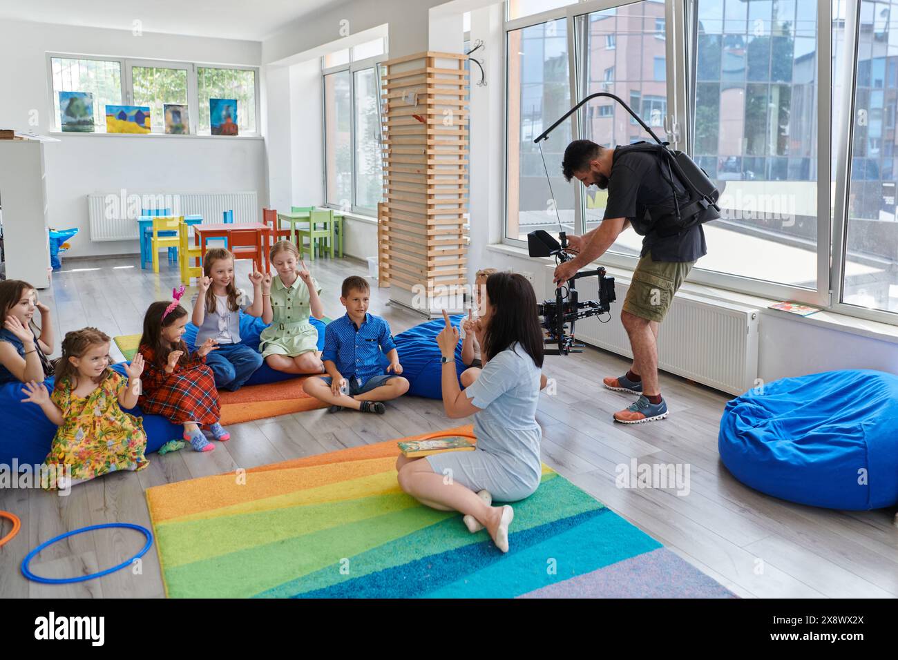 Cameraman films the joyful play and creative exploration of children at a preschool Stock Photo ...