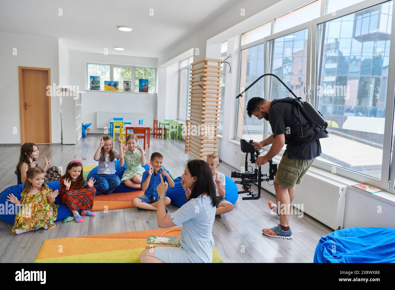 Cameraman films the joyful play and creative exploration of children at ...