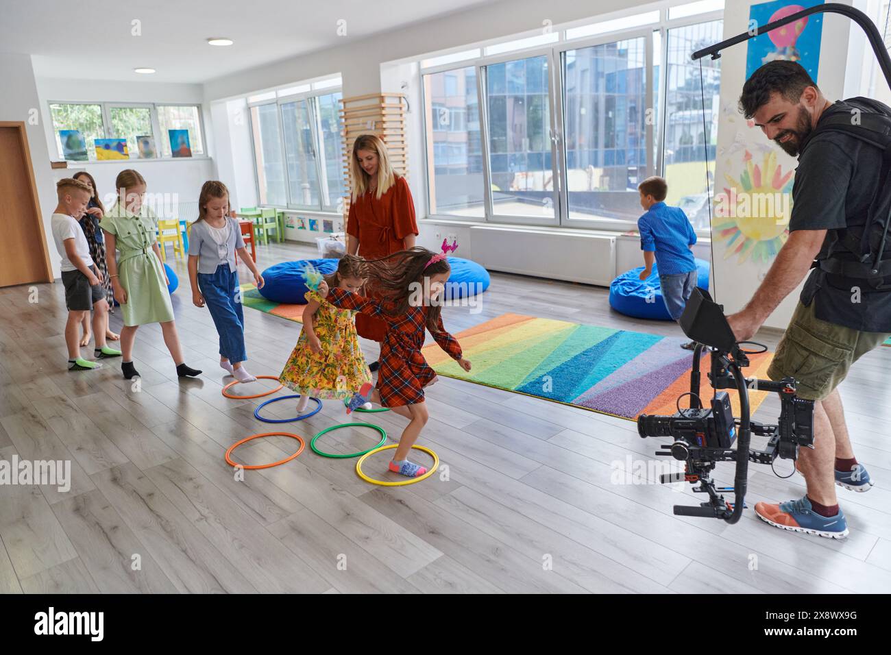 Cameraman films the joyful play and creative exploration of children at ...