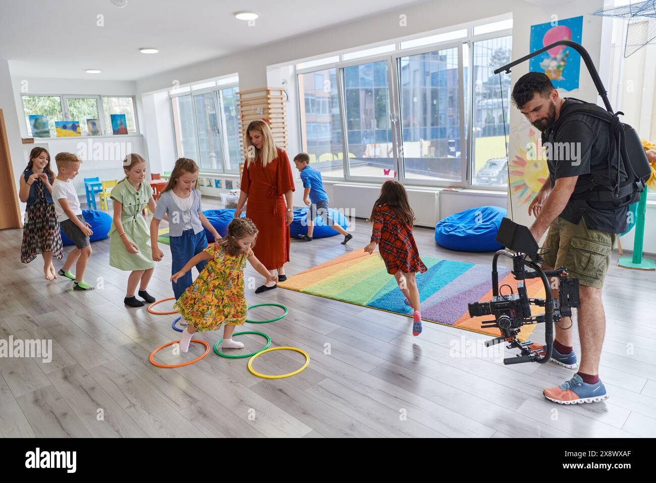 Cameraman films the joyful play and creative exploration of children at ...