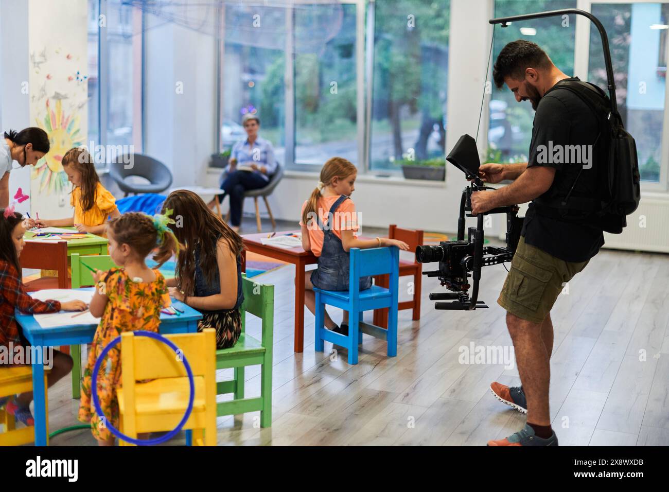Cameraman films the joyful play and creative exploration of children at ...