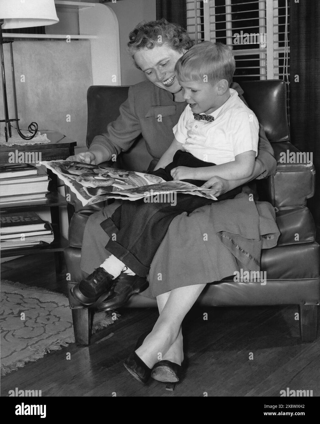 Reading with a book on her lap Black and White Stock Photos & Images ...