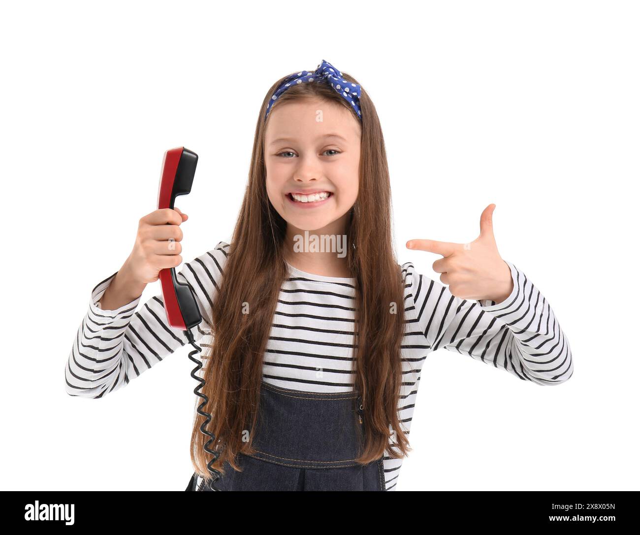 Little girl pointing at phone receiver on white background Stock Photo ...