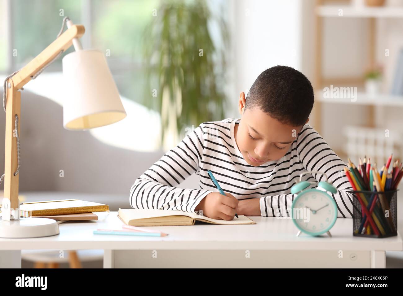 Little African-American boy doing lessons at home Stock Photo - Alamy