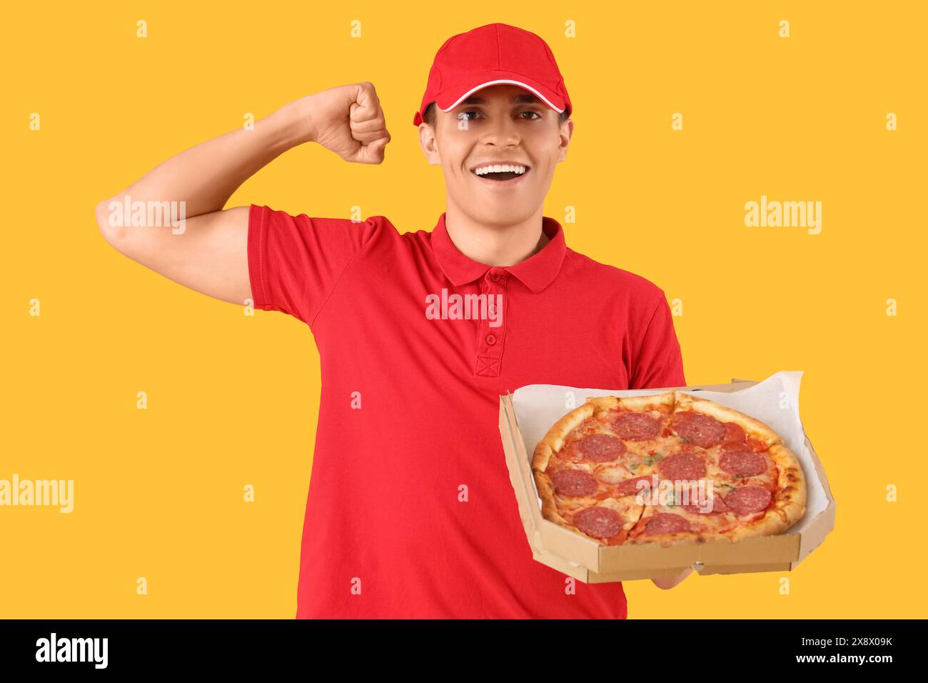 Male courier with tasty pepperoni pizza on yellow background Stock ...