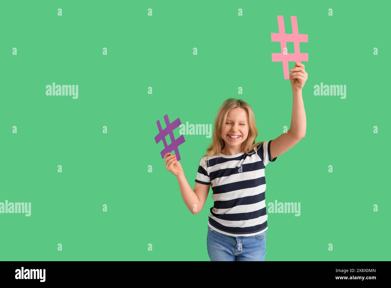 Cute teenage girl with hashtags on green background Stock Photo - Alamy