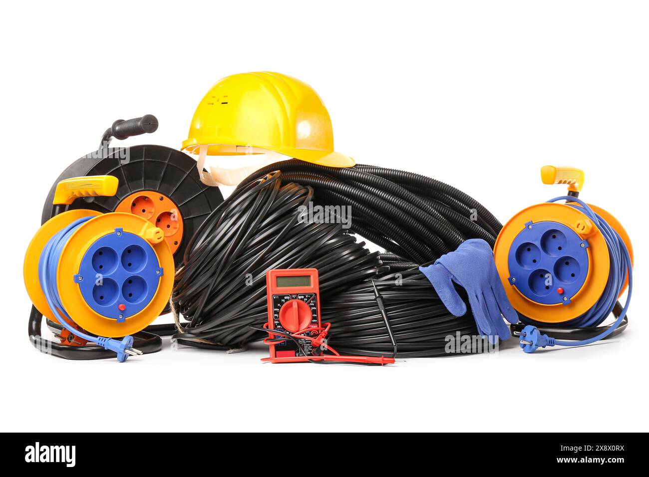 Rolled wires, multimeter, hardhat and extension cable reels on white ...