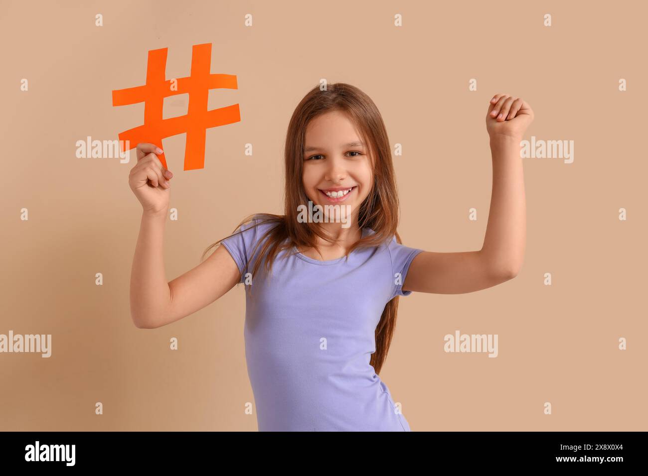 Cute teenage girl with hashtag on beige background Stock Photo - Alamy