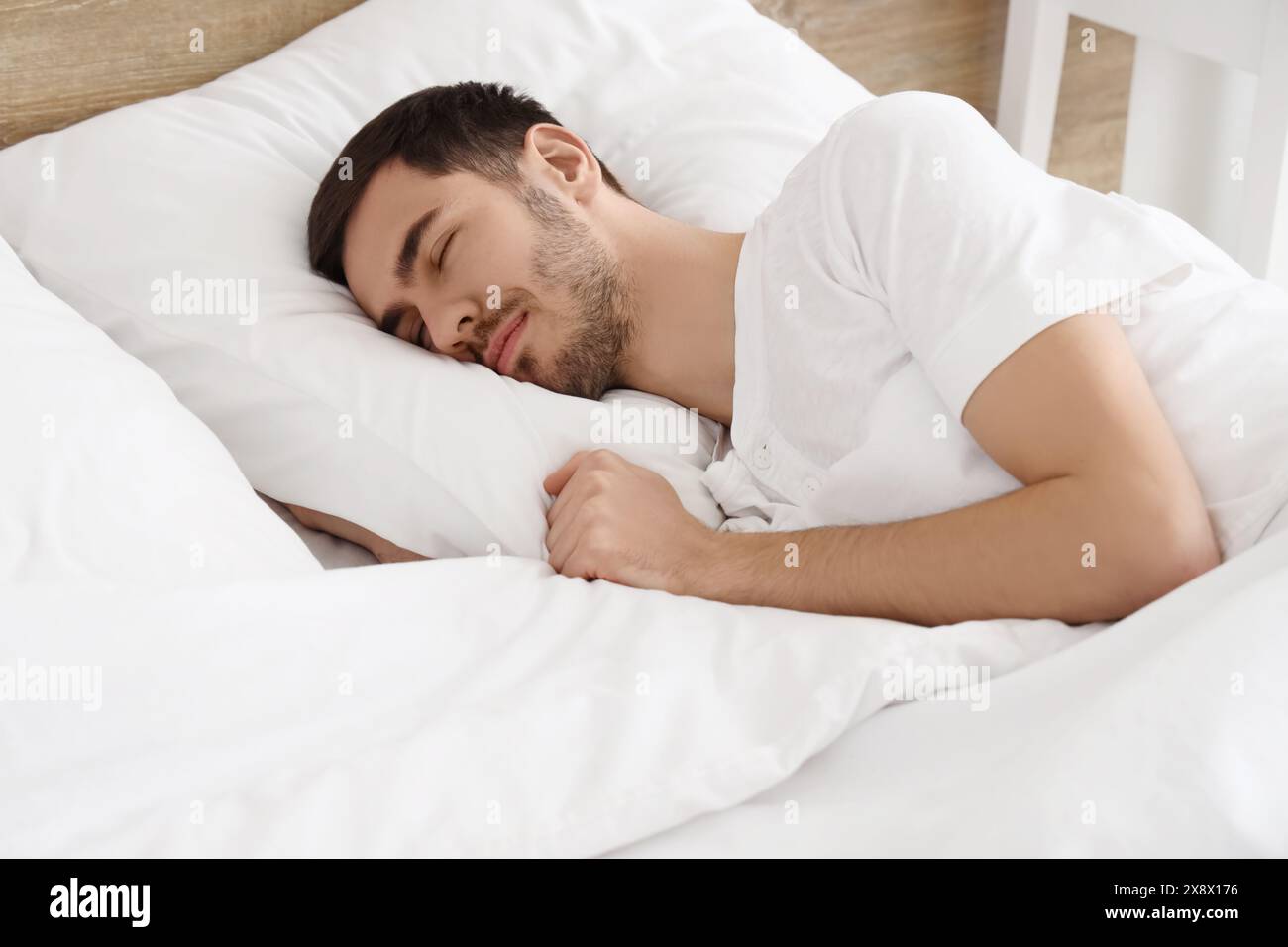Handsome young man sleeping in bed Stock Photo - Alamy