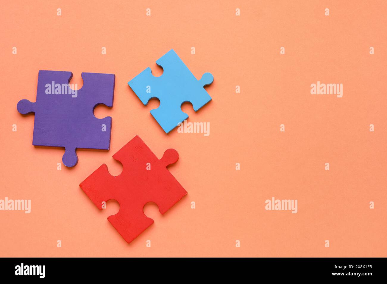 Colorful puzzle pieces on orange background. Concept of autistic ...