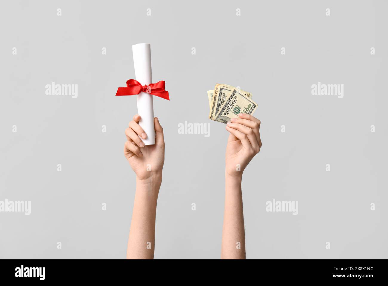 Female hands holding diploma and money on white background Stock Photo ...