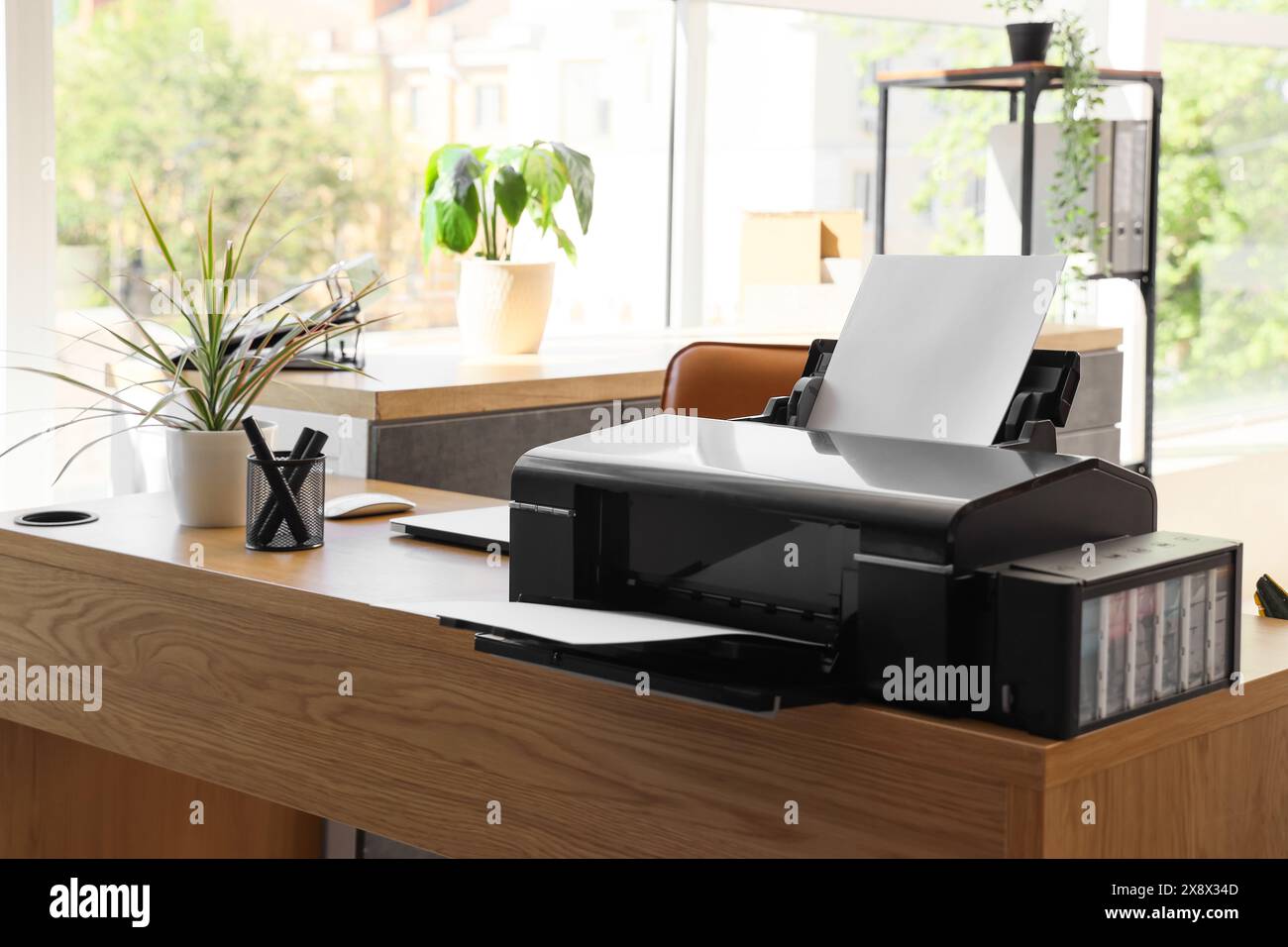 Modern printer on desk in office Stock Photo - Alamy