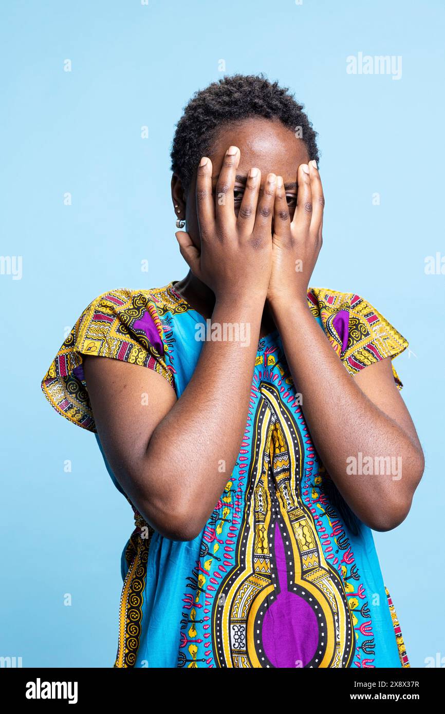 Woman of African American descent closes her eyes in disbelief and ...