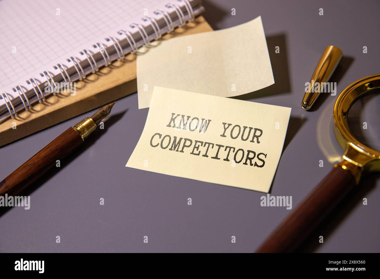 KNOW YOUR COMPETITORS text in office notebook with keyboard, magnifier ...