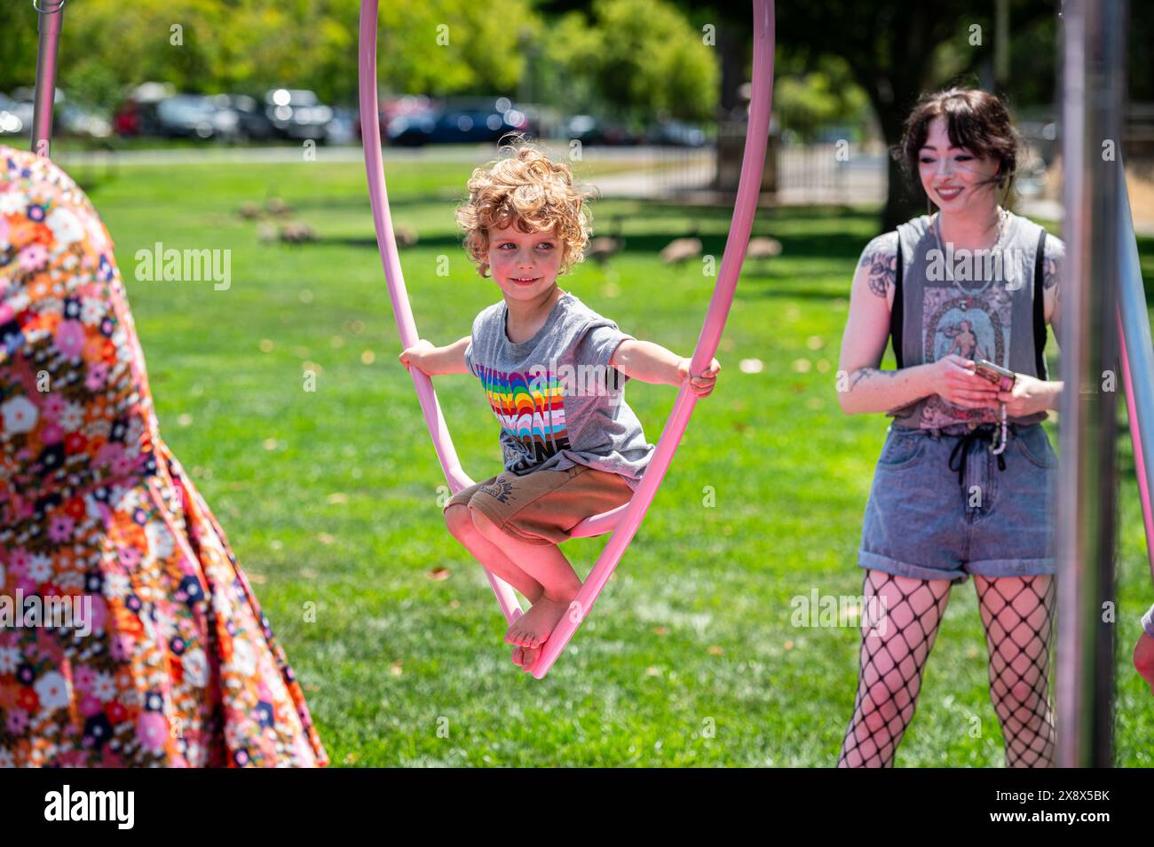 A child wearing a t-shirt with the words "Everyone" in the colors of ...