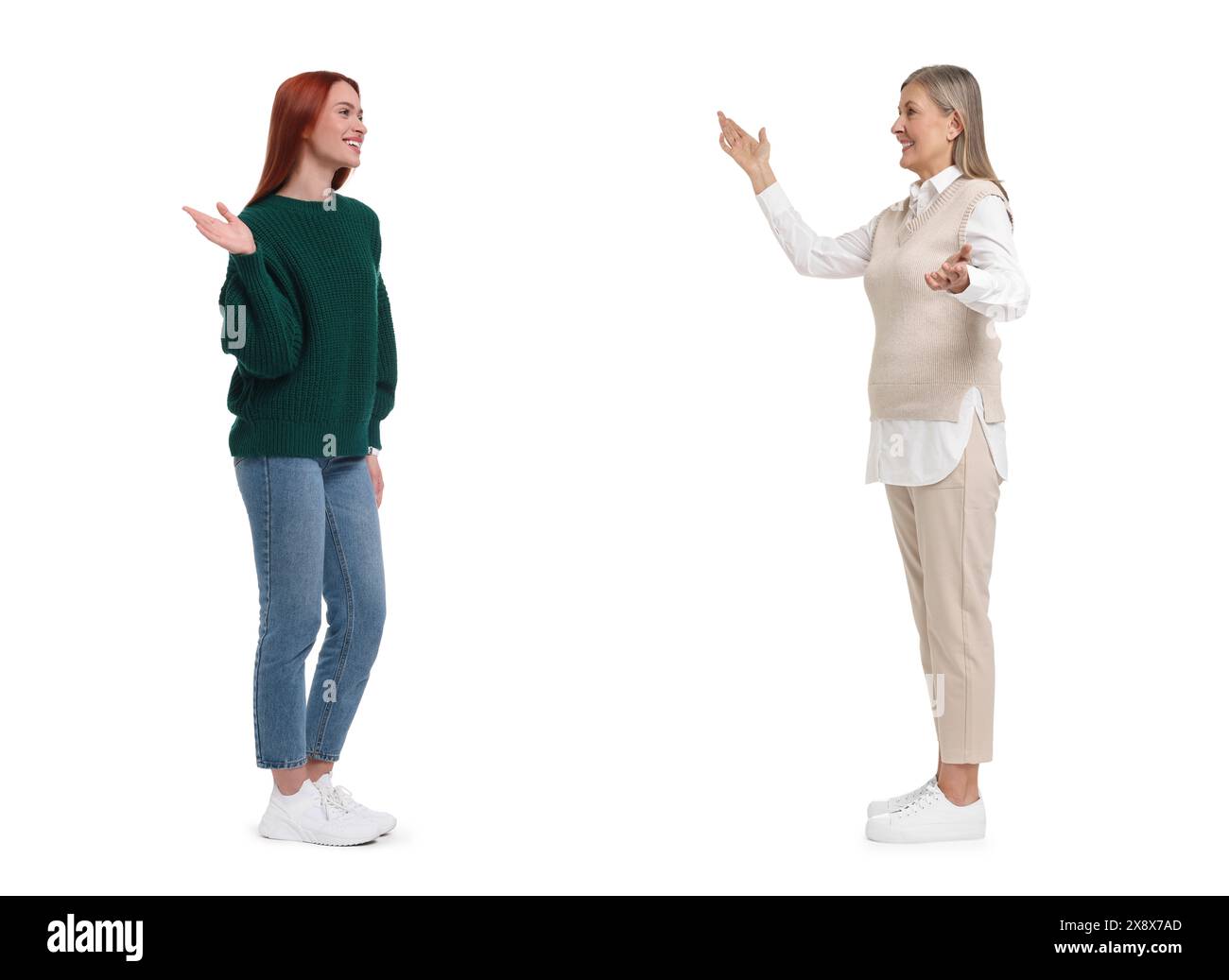 Two women talking on white background. Dialogue Stock Photo - Alamy