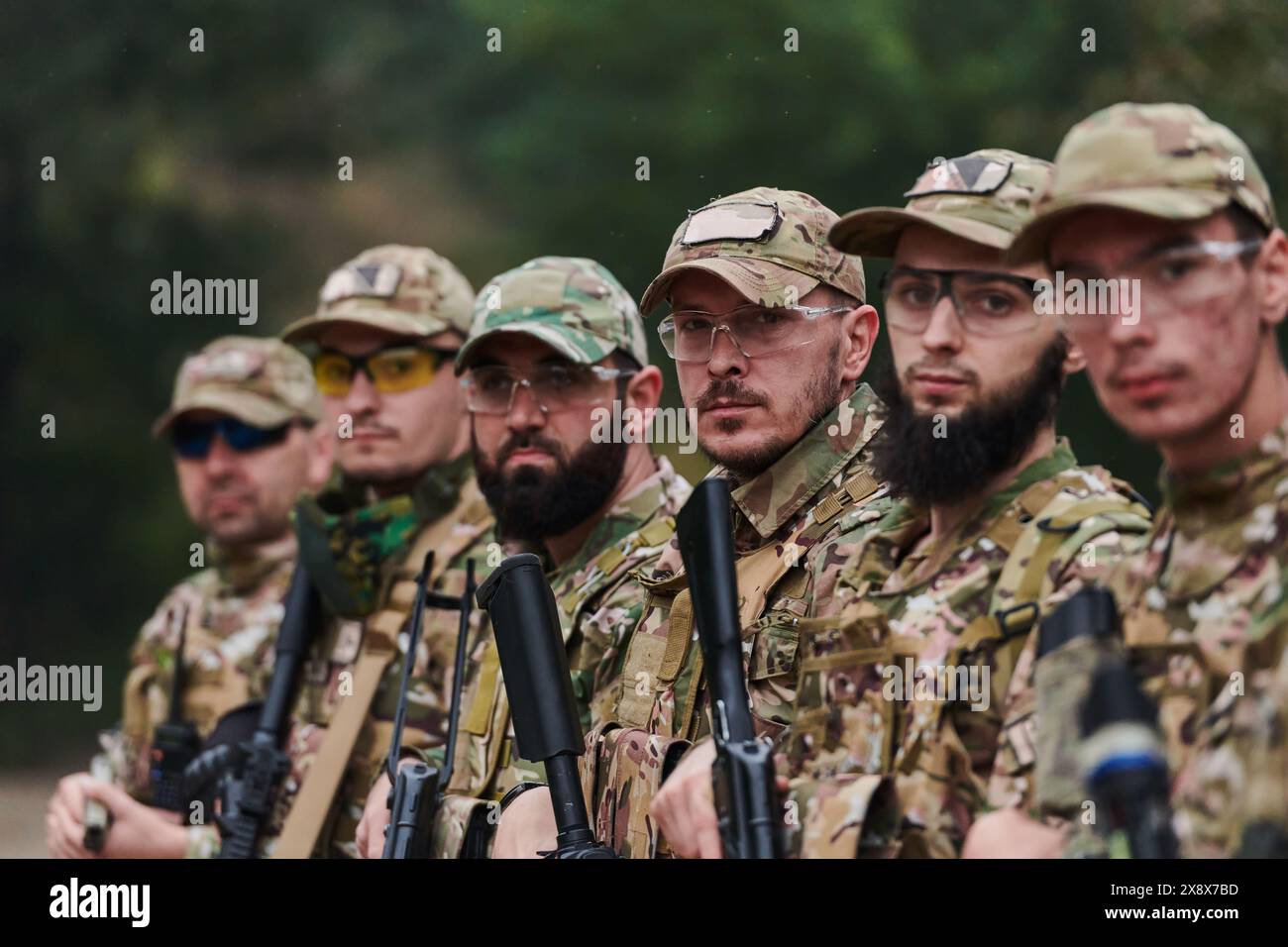 Soldier fighters standing together with guns. Group portrait of US army ...