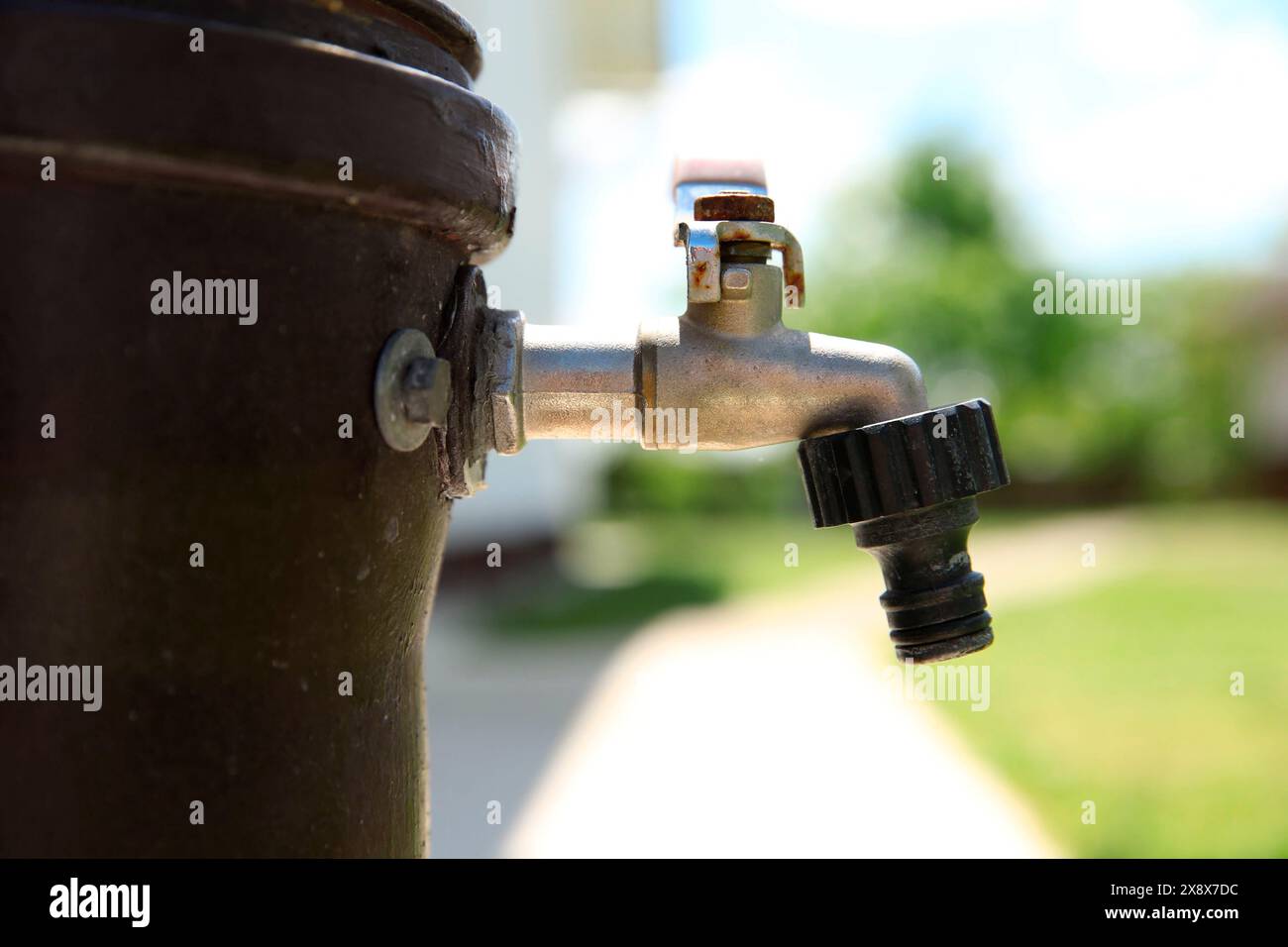 Metal water tap outdoors on sunny day Stock Photo - Alamy