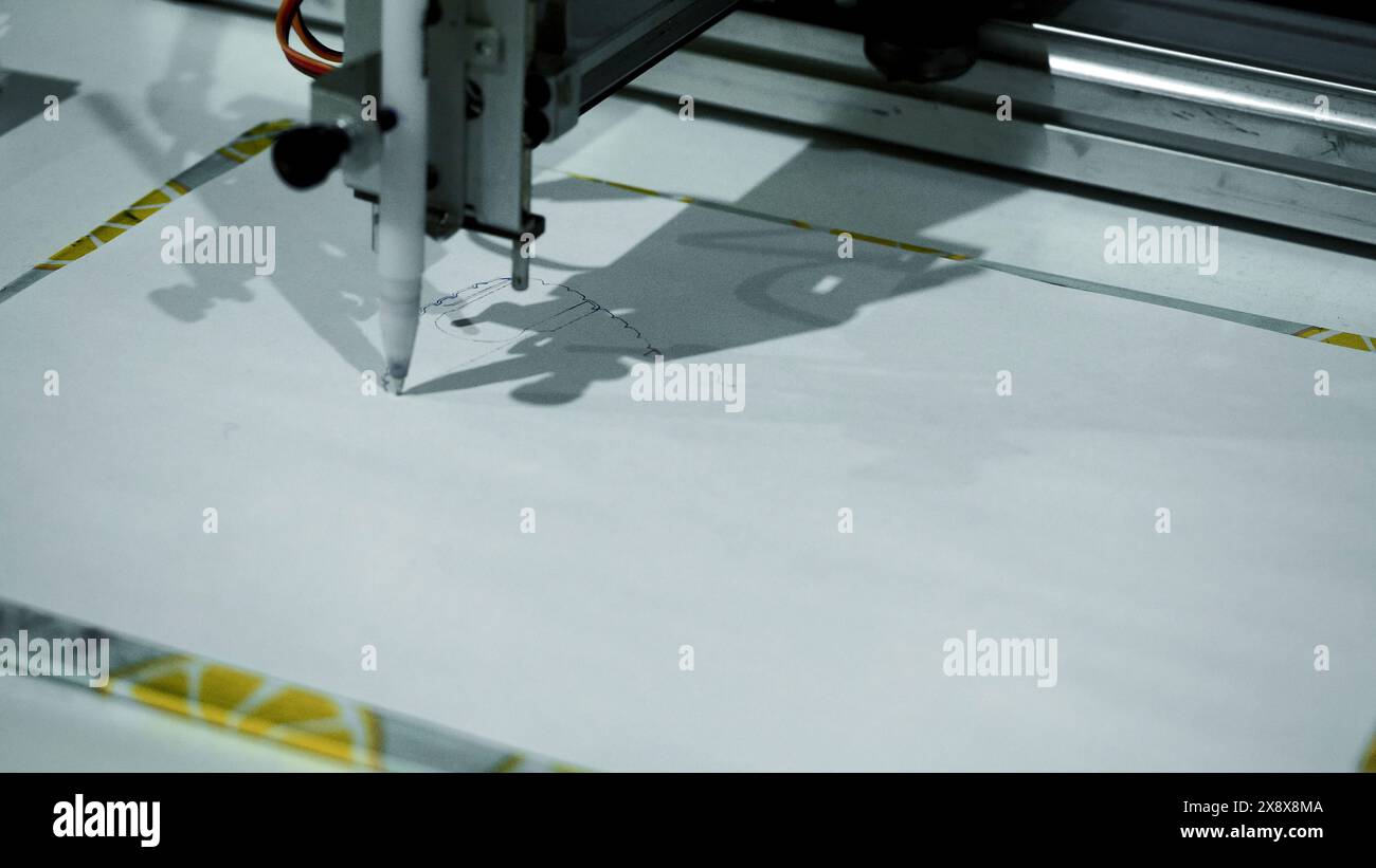 Automated machine draws image on paper. Media. Robotic machine that ...