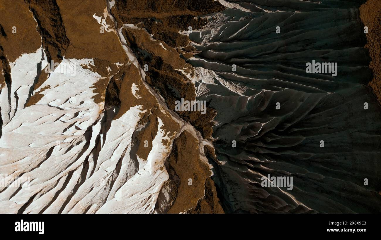Aerial of wide gorge with rocky cliffs from both sides of small canyon ...