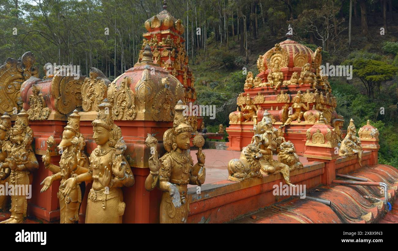 Hindu temple with golden statues. Action. Red temple with golden ...