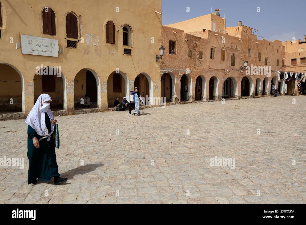 A veiled woman walking on main square of Ghardaia, one of the Ksar ...