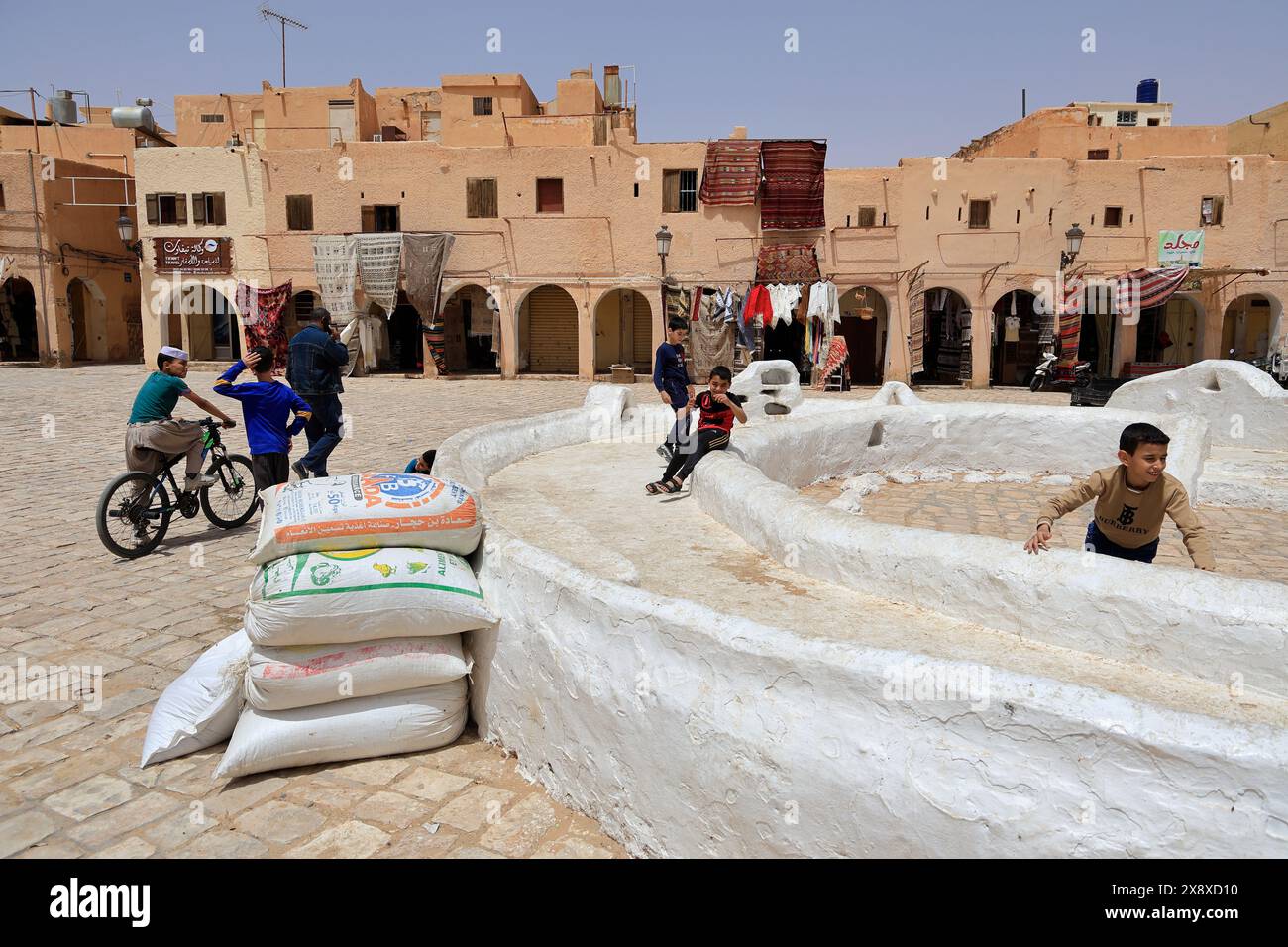 Children playing in the main square of Ghardaia with traditional ...