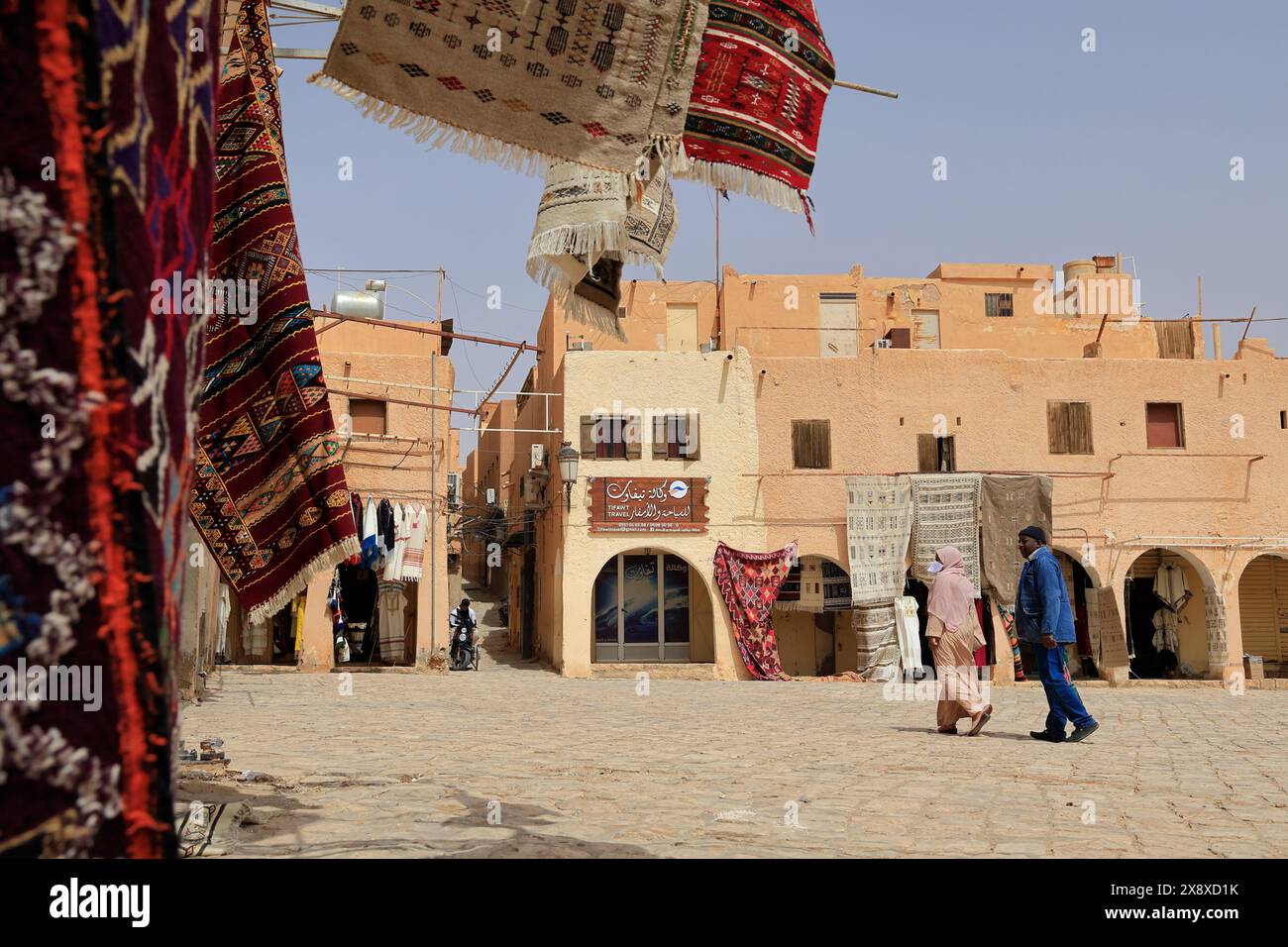 Carpet market in the main square of Ghardaia with traditional dwellings ...