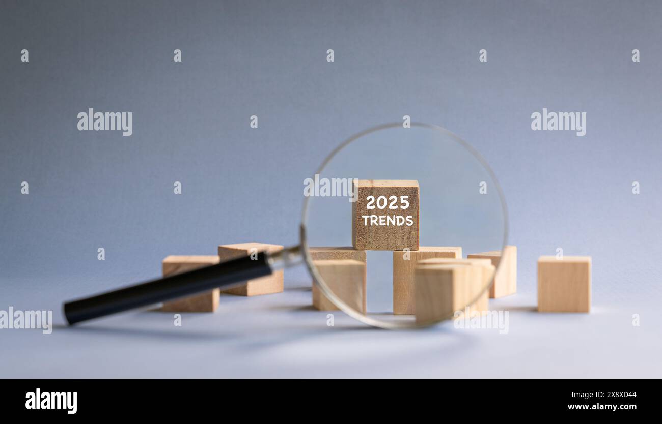 2025 Trends, text on wood block, with magnifying glass. New year ...