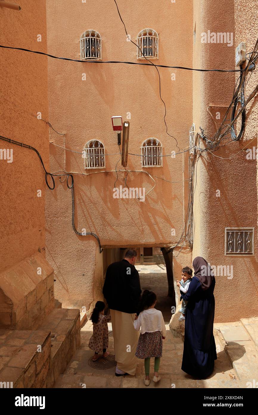 Visitors in front of a traditional dwellings with small window and ...