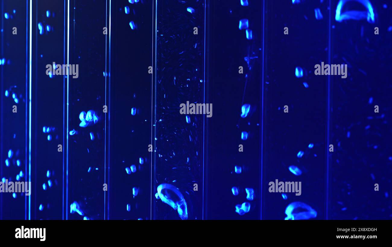 Close up of underwater view of air bubbles in colored liquid substance ...