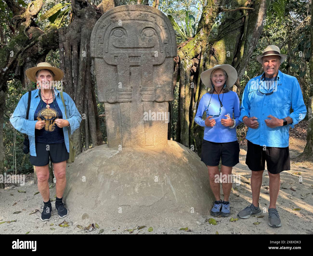 Visitors mimic the two thousand year old stone carvings in the San ...
