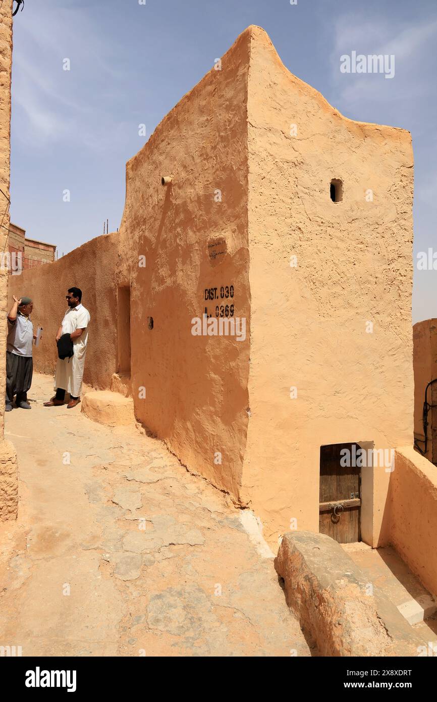 Traditional Mozabite architectures in Ksar Beni Isguen with two men ...
