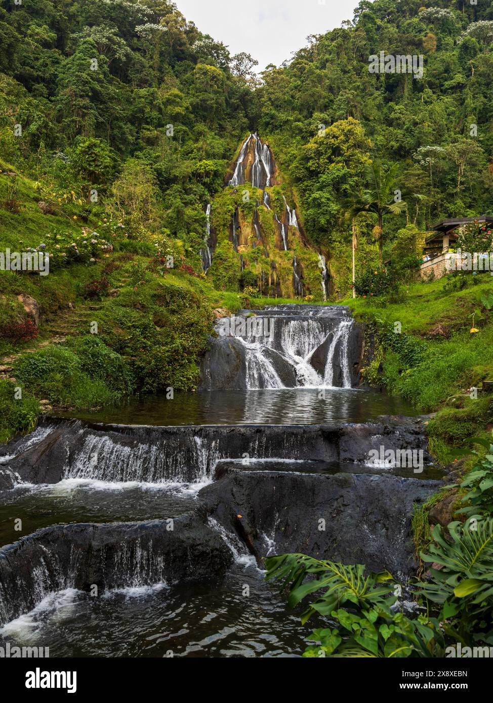 A beautiful waterfall sits above the Santa Rosa de Cabal hot springs ...