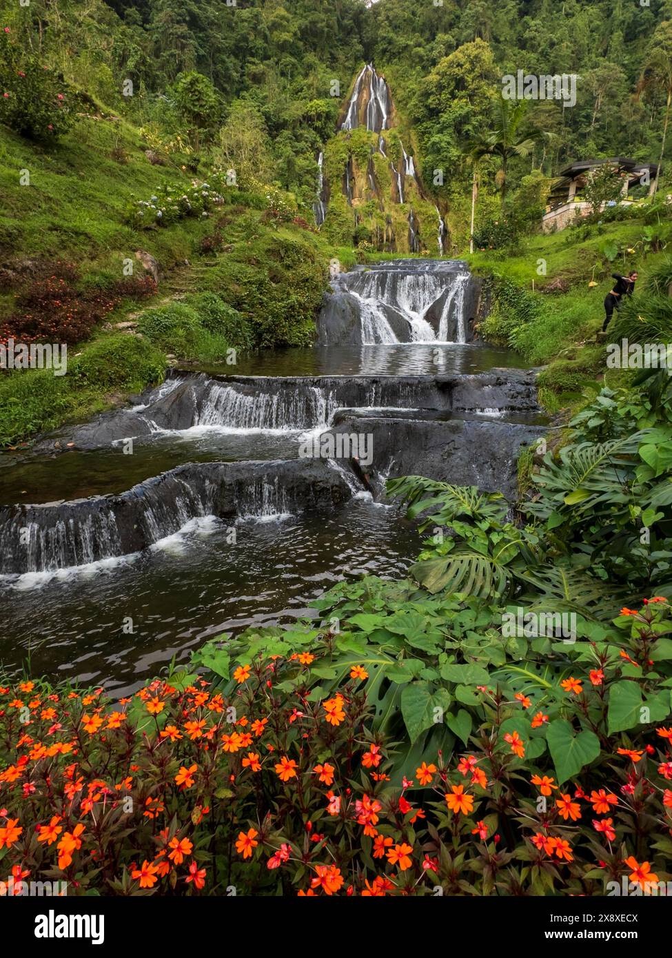 A beautiful waterfall sits above the Santa Rosa de Cabal hot springs ...