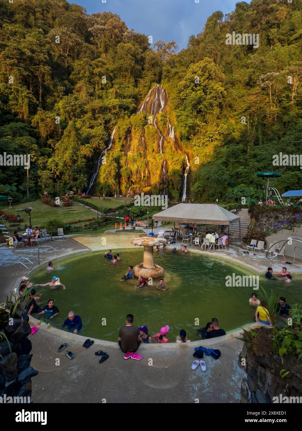 A beautiful waterfall sits above the Santa Rosa de Cabal hot springs ...