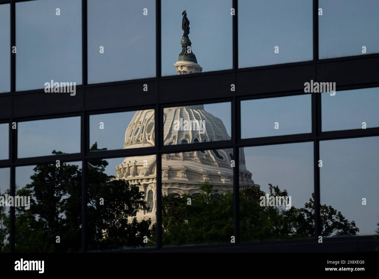 A general view of the U.S. Capitol Building dome reflected in a window ...