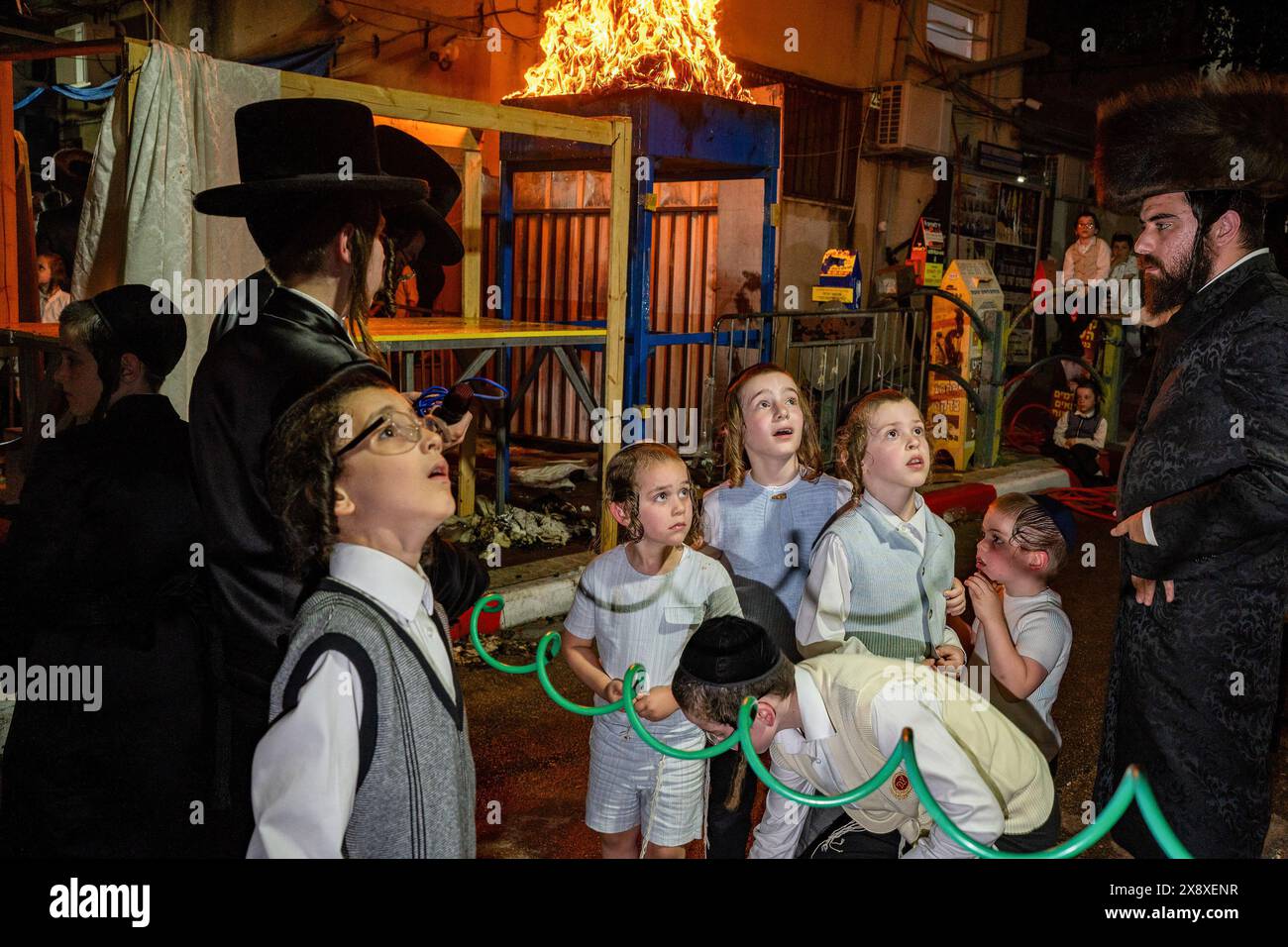 Orthodox Jewish kids play near the bonfire of Lag Ba'omer. Lag Ba'omer ...