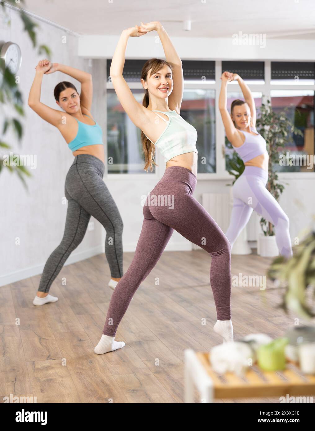 Positive women engaged in active dancing Stock Photo - Alamy