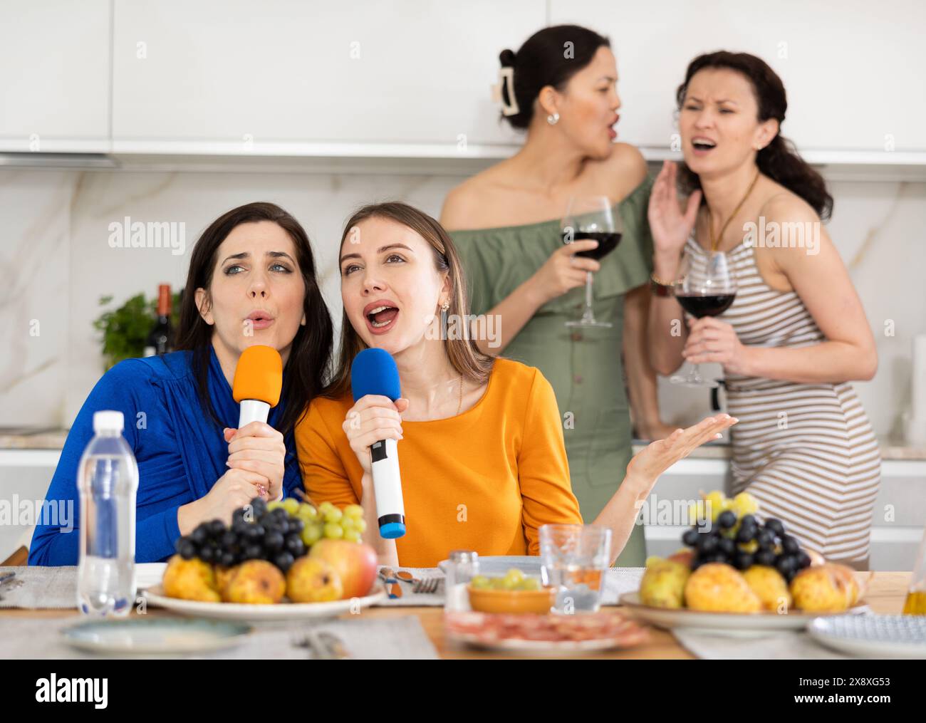 Group of women friends singing karaoke Stock Photo - Alamy